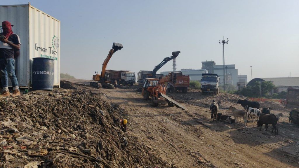 Machines are digging, dragging, tearing into Delhi garbage mountains ...